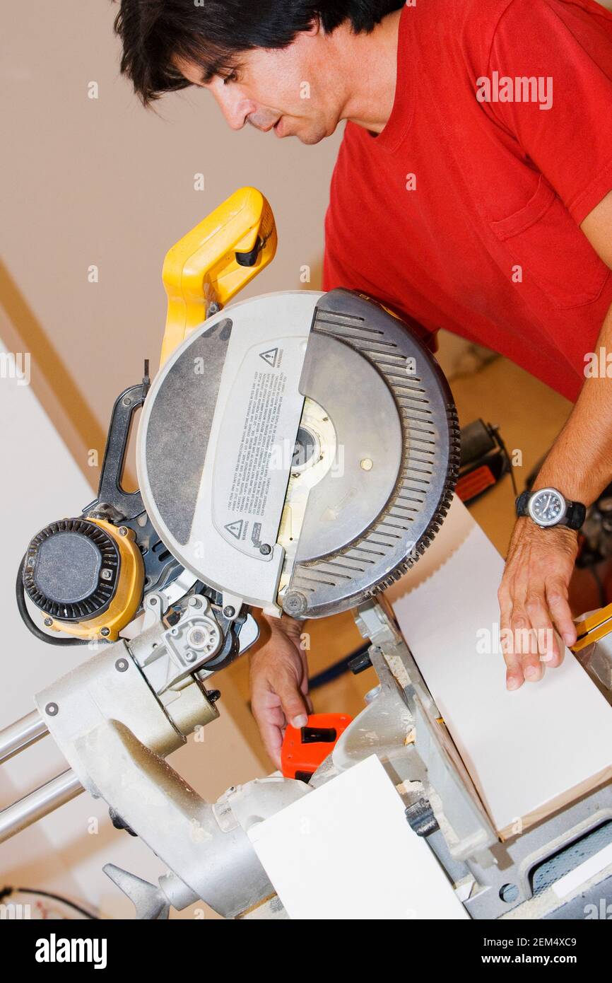 Hispanic carpenter using circular saw hi-res stock photography and ...