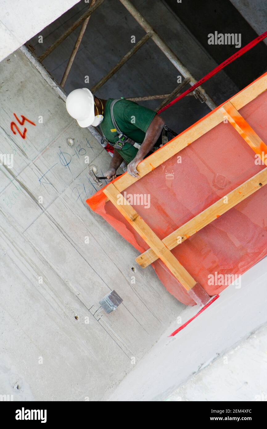 Construction worker making a wooden frame at a construction site Stock ...