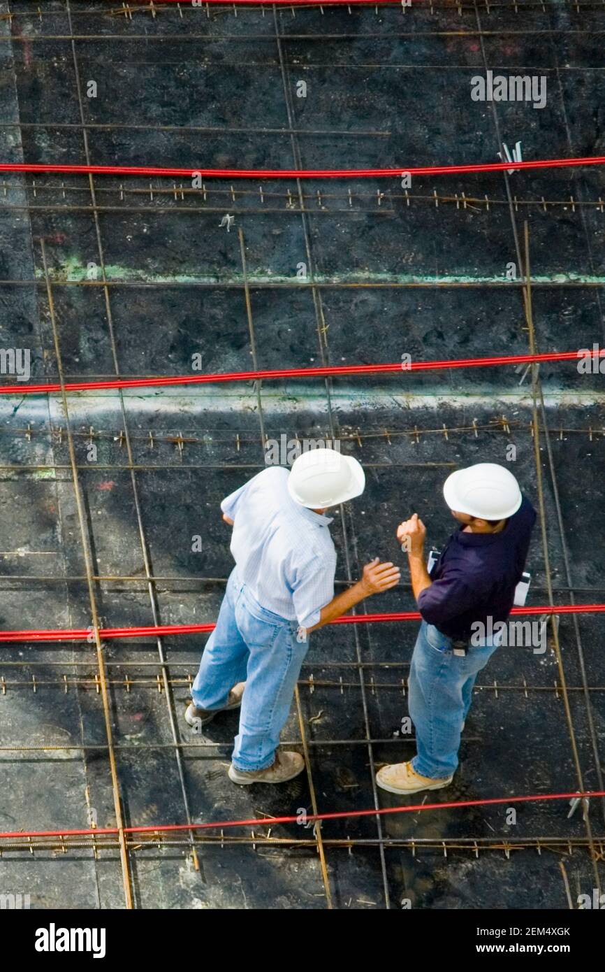 High angle view of two architects standing at a construction site Stock ...