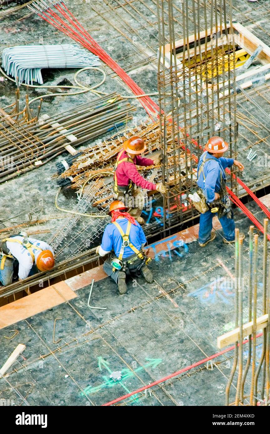 High angle view of four construction workers working at a construction ...