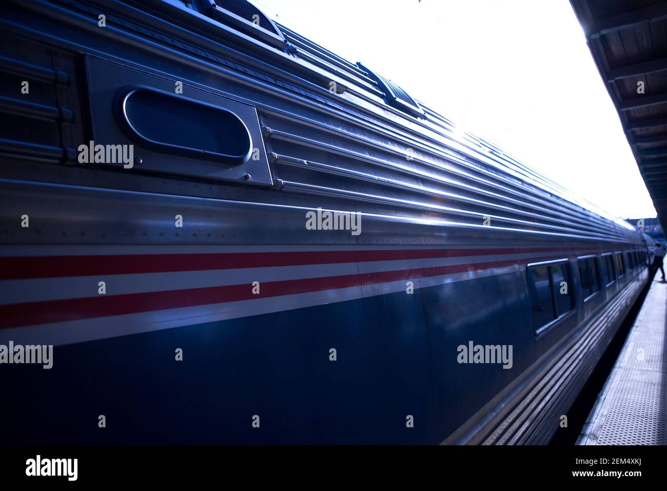 Passenger train at a railroad station platform Stock Photo - Alamy