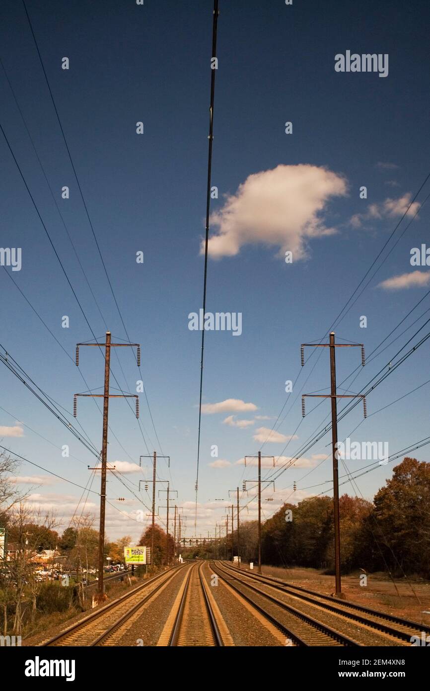 Electricity pylons near railroad tracks Stock Photo - Alamy