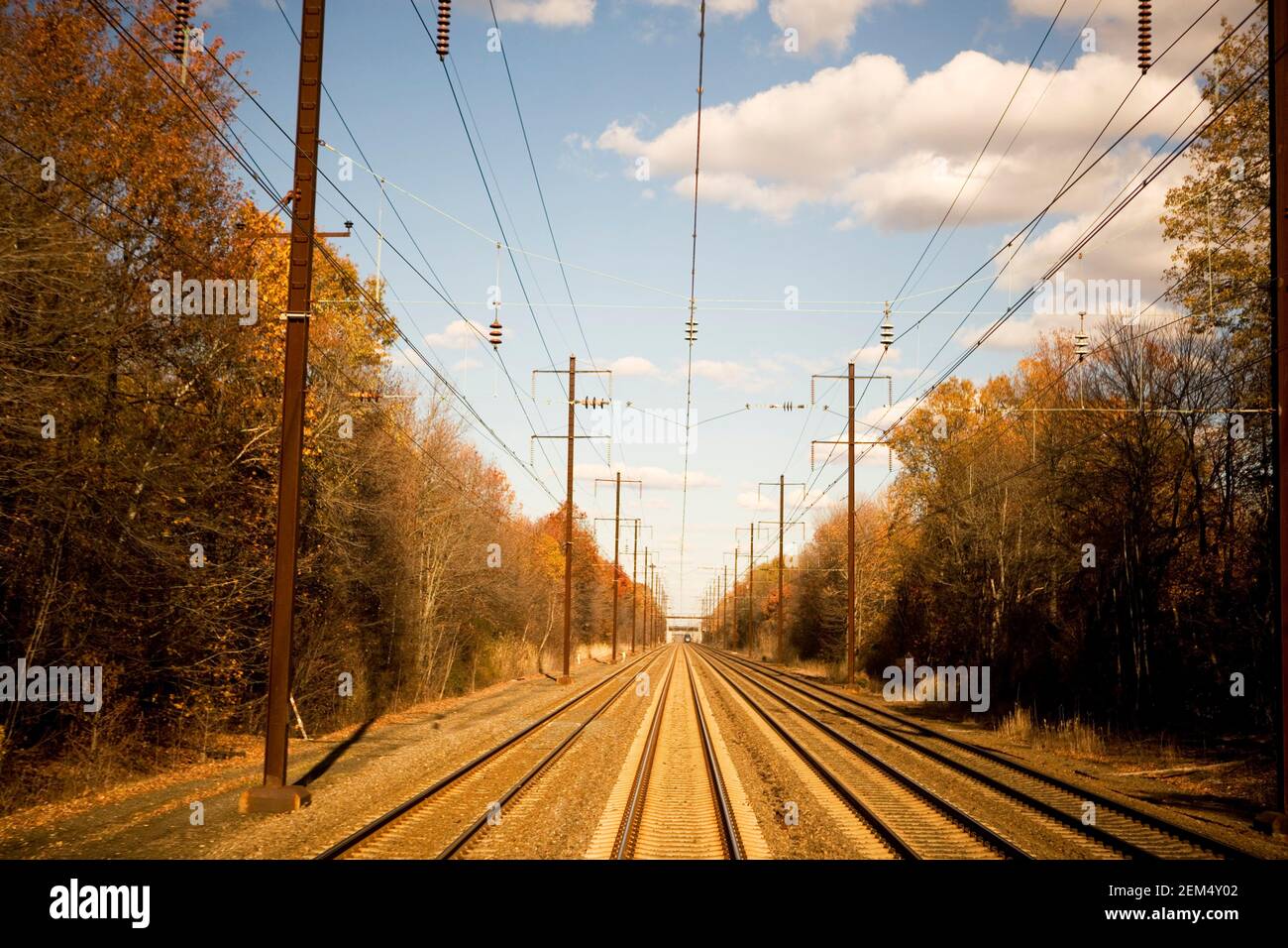 Electricity pylons near railroad tracks Stock Photo - Alamy