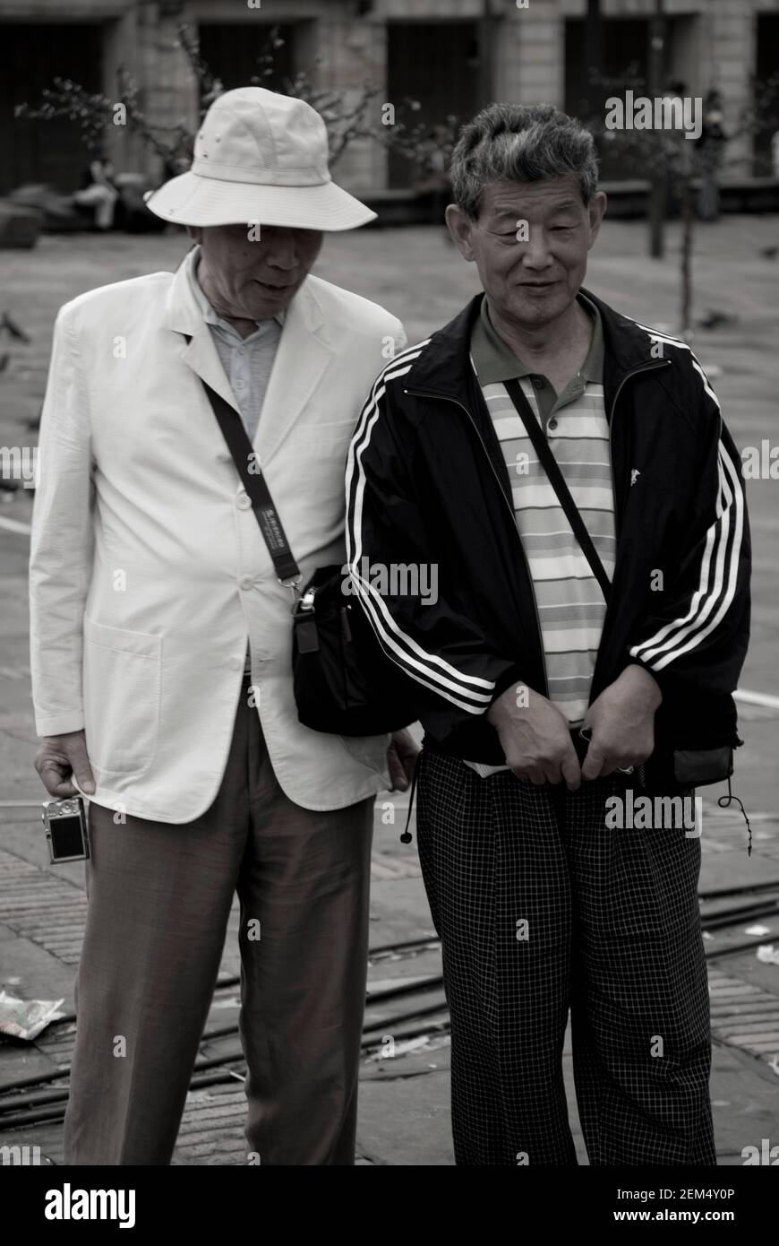 Senior man and a mature man standing together Stock Photo - Alamy