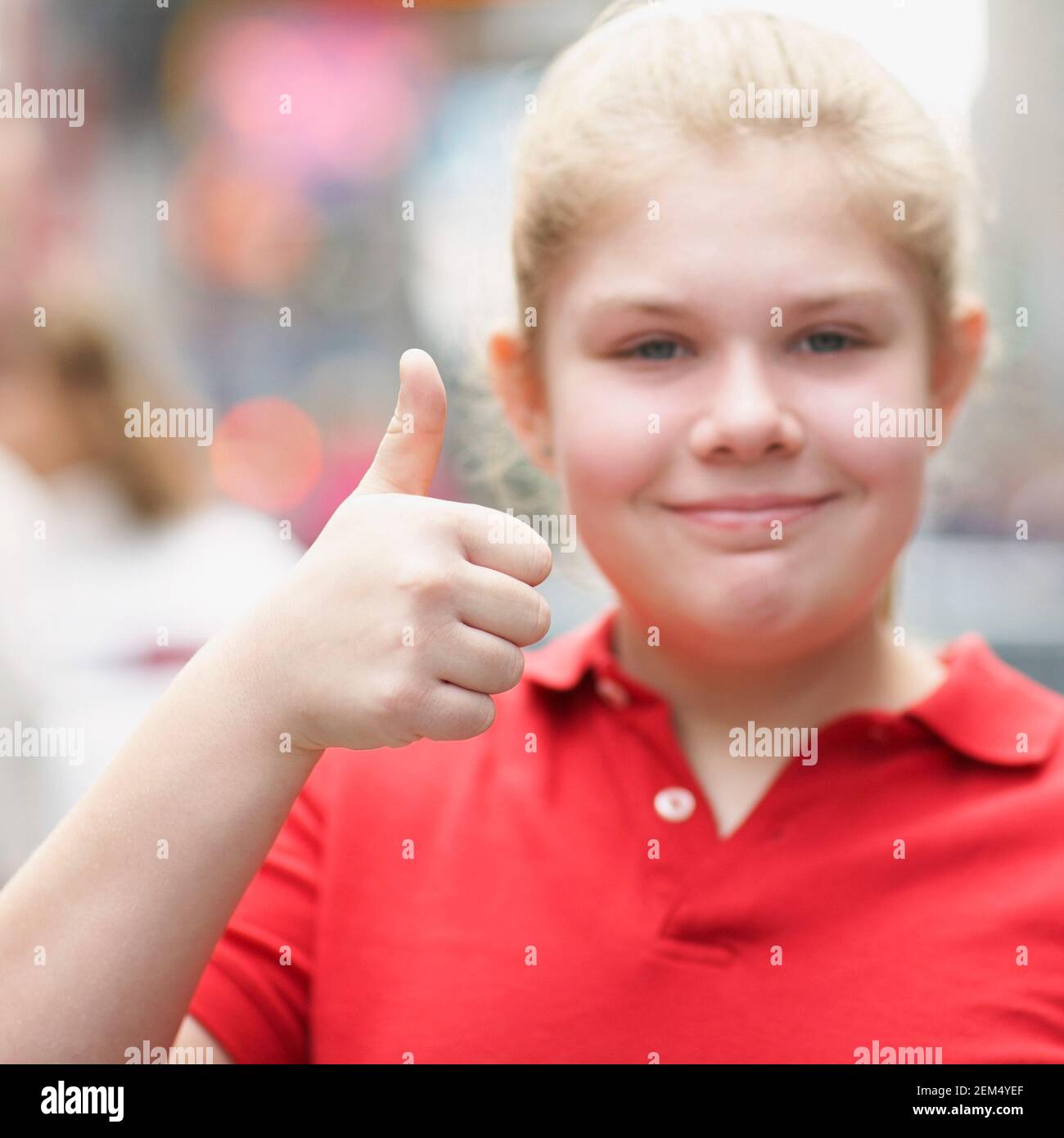 Portrait of a teenage girl showing thumbs up sign Stock Photo - Alamy
