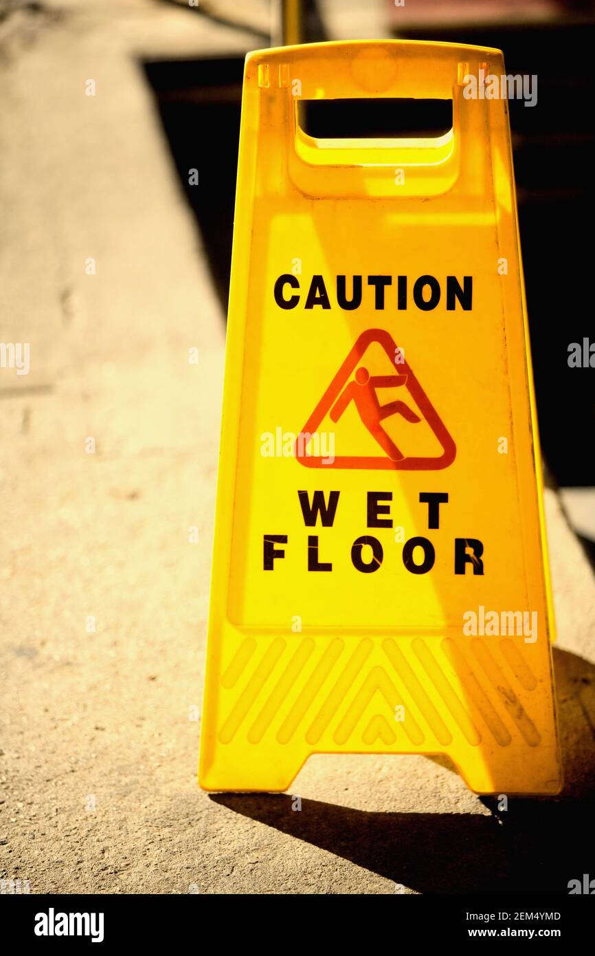 Close-up of a wet floor signboard Stock Photo - Alamy