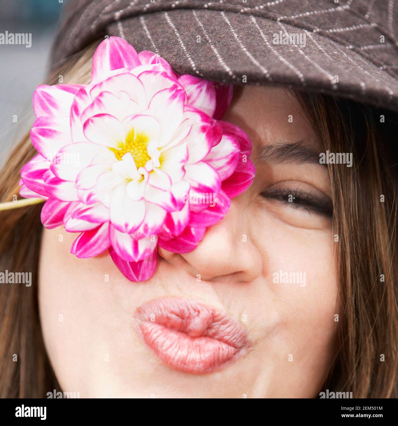 Portrait of a young woman covering his eye with a flower Stock Photo ...