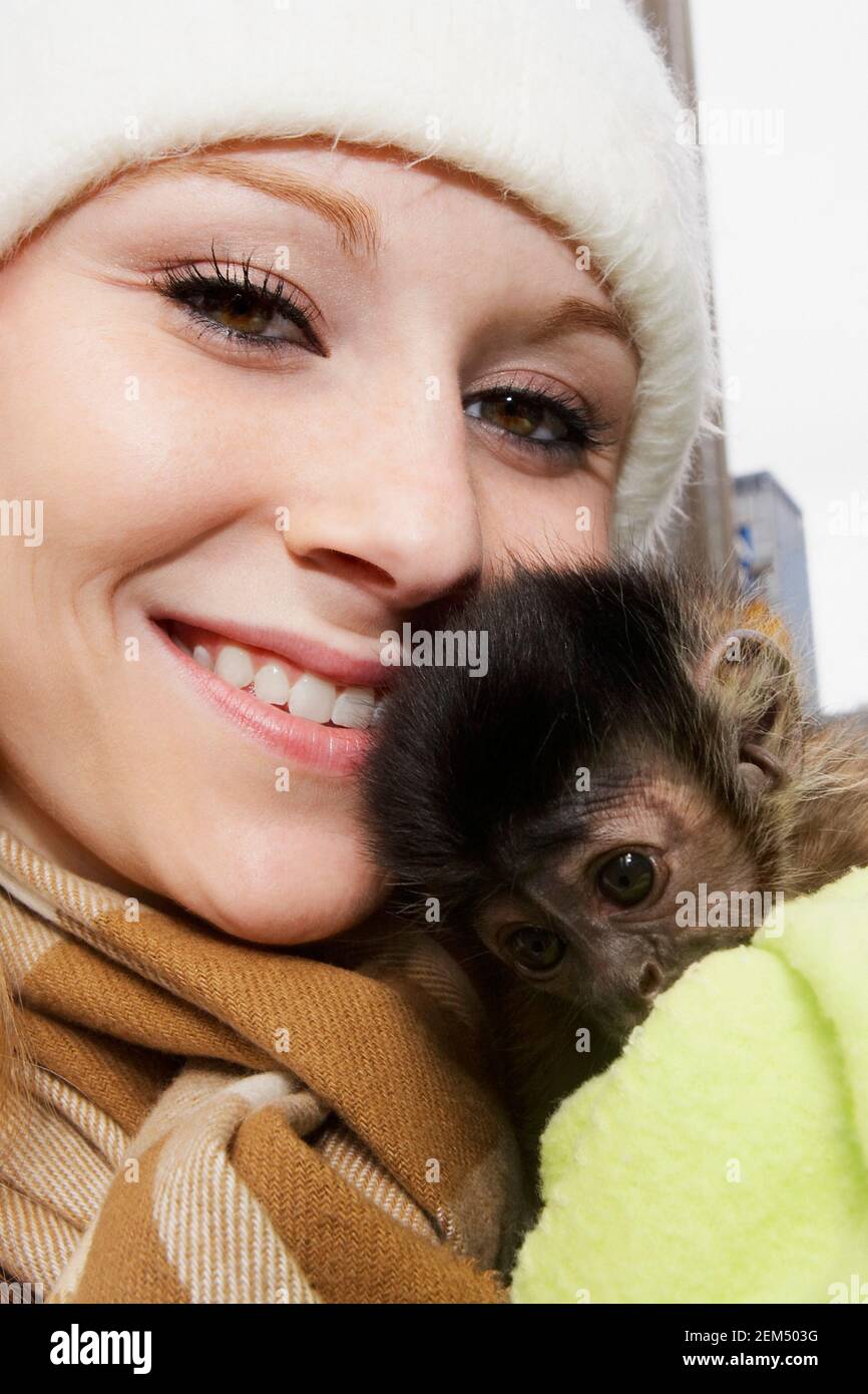 Person holding animal monkey hi-res stock photography and images - Alamy