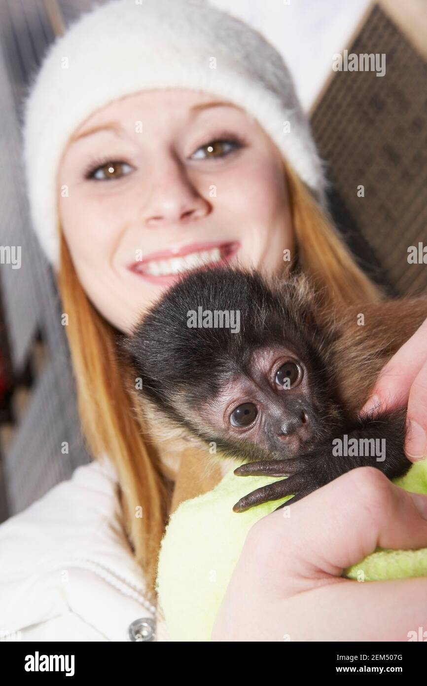 Person holding animal monkey hi-res stock photography and images - Alamy