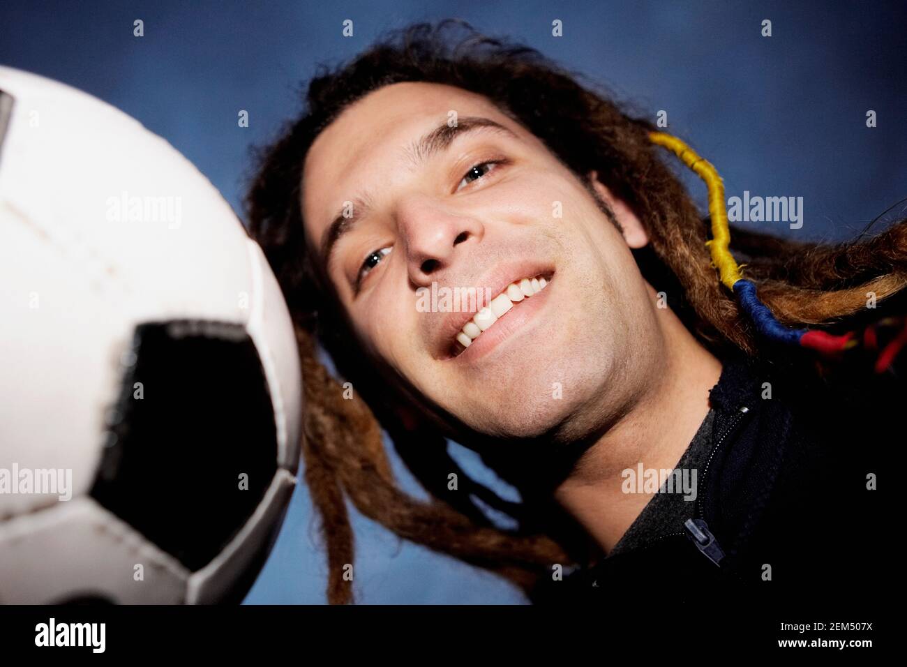 Portrait of a young man smiling with a soccer ball Stock Photo - Alamy