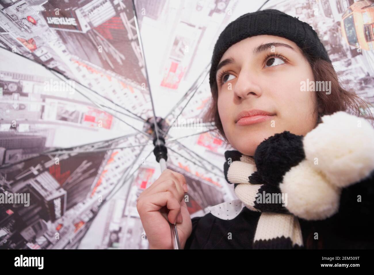 Low angle view of a teenage girl holding an umbrella Stock Photo - Alamy