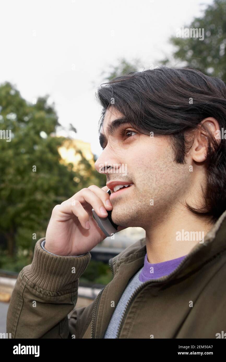 Side profile of a young man using a mobile phone Stock Photo - Alamy