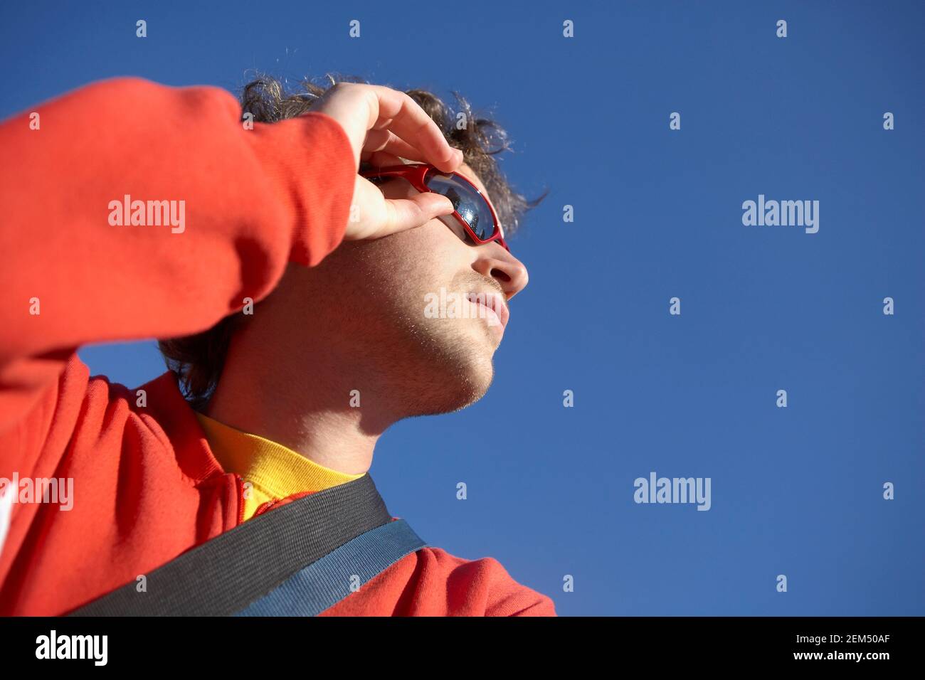 Low angle view of a young man looking away Stock Photo - Alamy