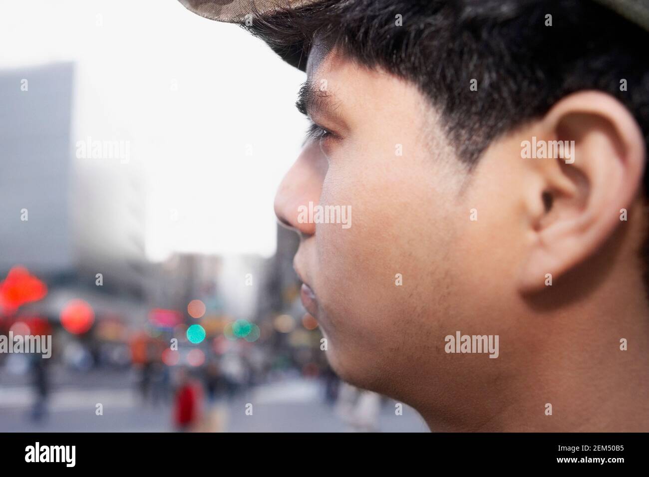 Side profile of a young man wearing a cap and looking away Stock Photo ...