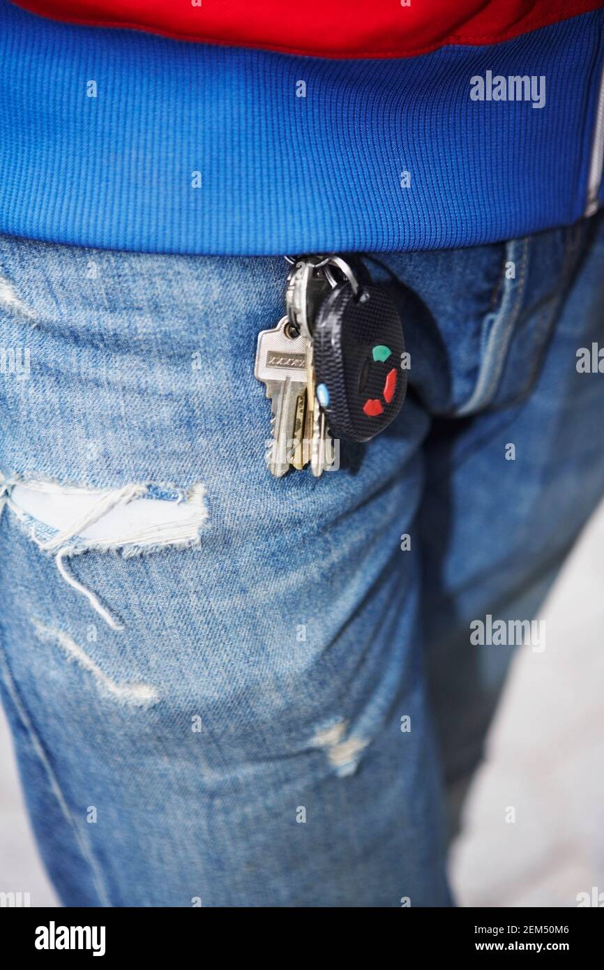 Mid section view of a person with a car key Stock Photo - Alamy