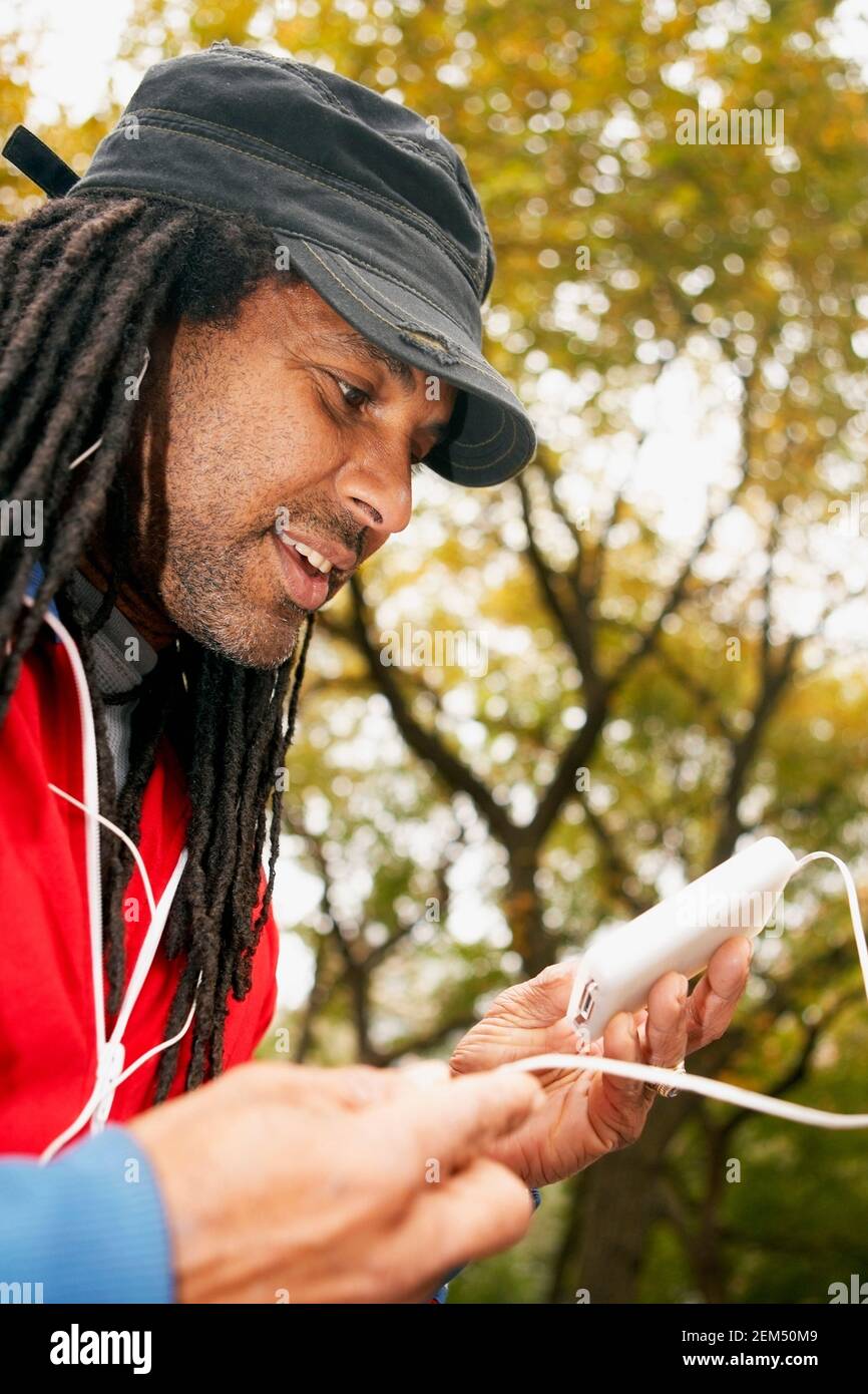 Side profile of a mature man looking at an MP3 player Stock Photo - Alamy