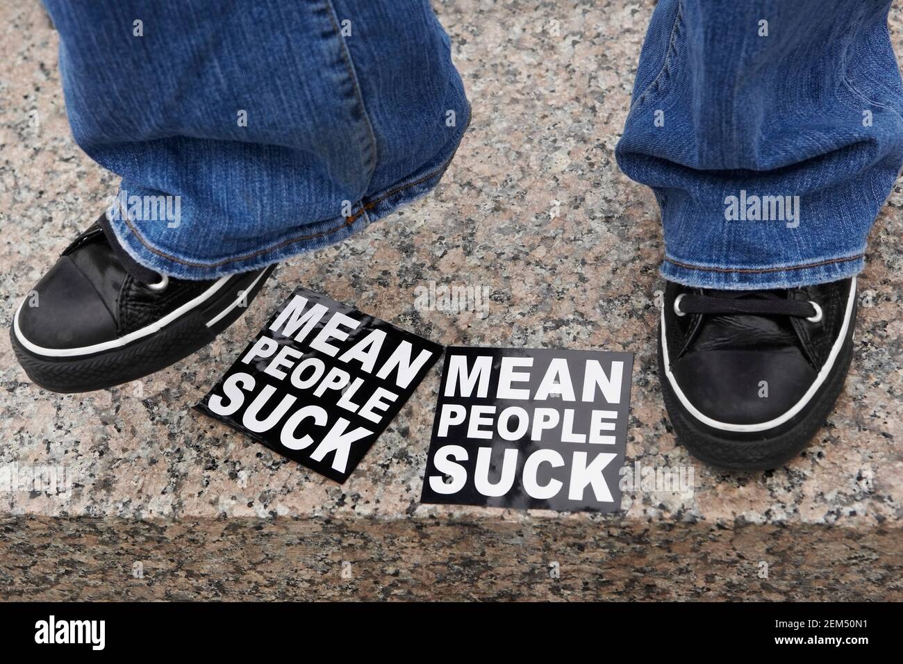 Low section view of a person standing near two placard Stock Photo - Alamy