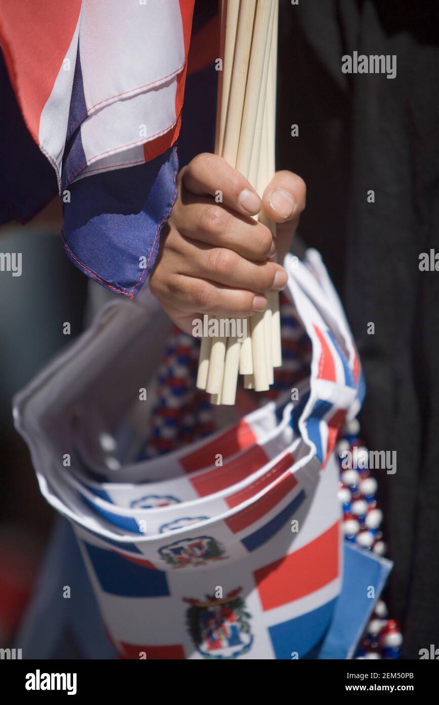 Close-up of a human hand holding sun visors and Dominican Republic ...