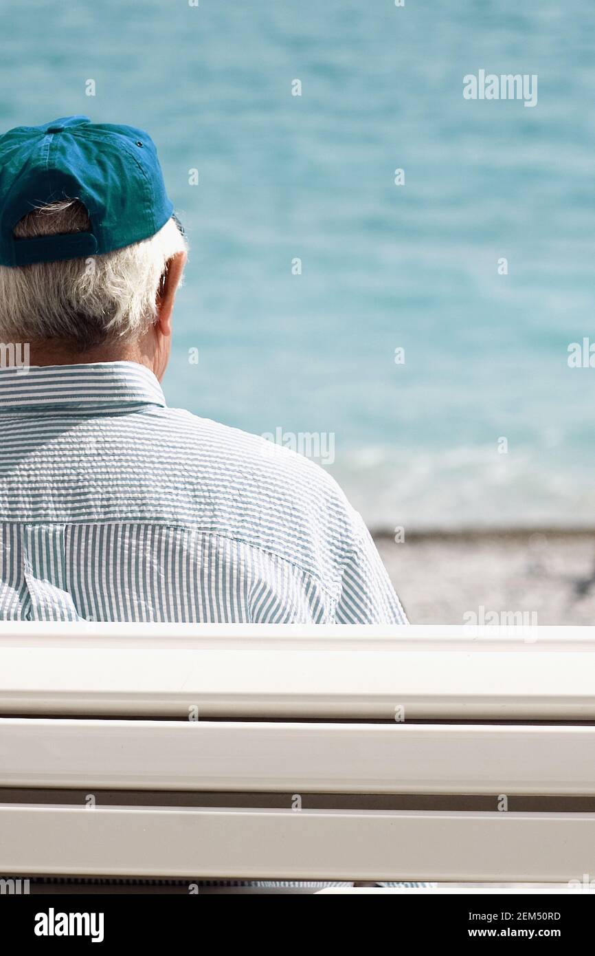 Rear view of a senior man sitting on a bench, Barcelona, Spain Stock ...