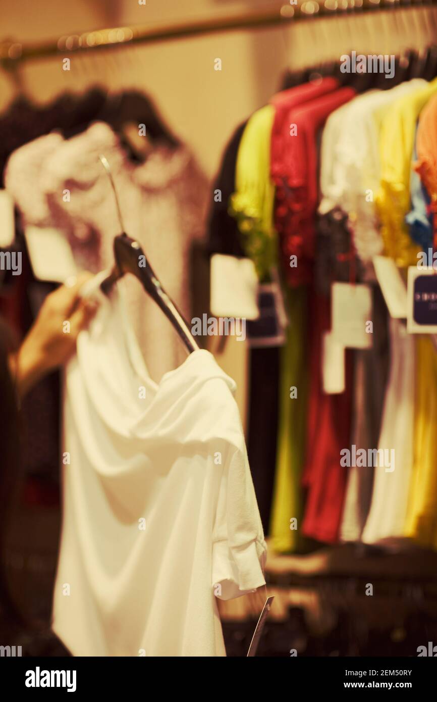 Close-up of a human hand holding clothes in a clothing store Stock ...