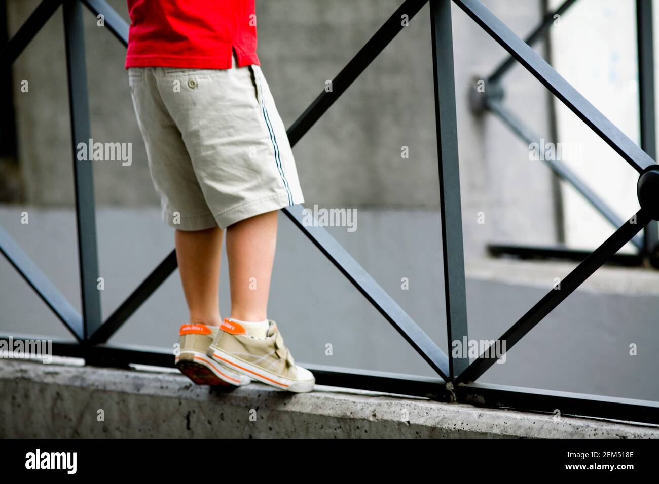 Boy leaning railing outdoors hi-res stock photography and images - Alamy