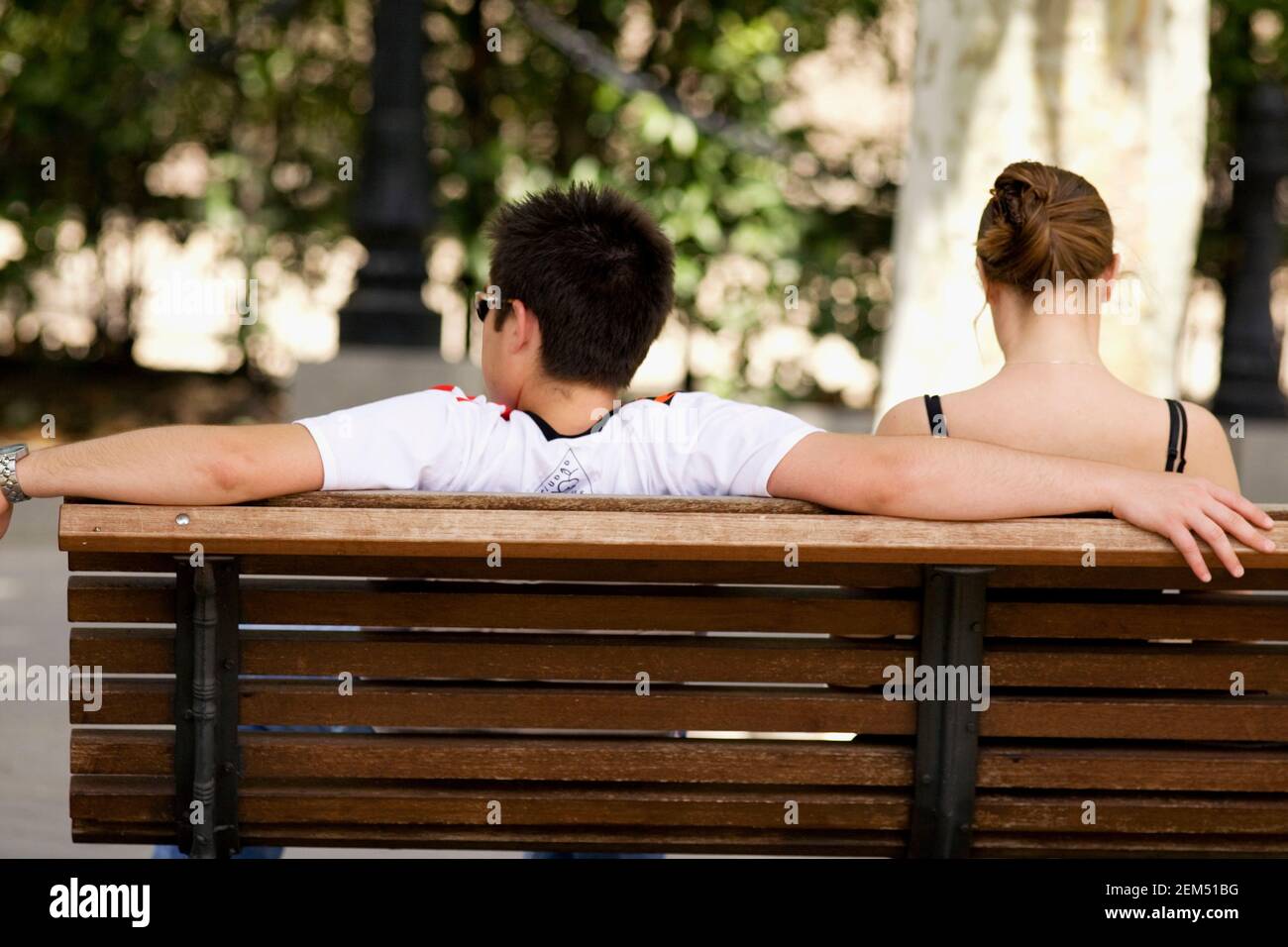 Rear view of a man and a woman sitting on a bench, Madrid, Spain Stock ...