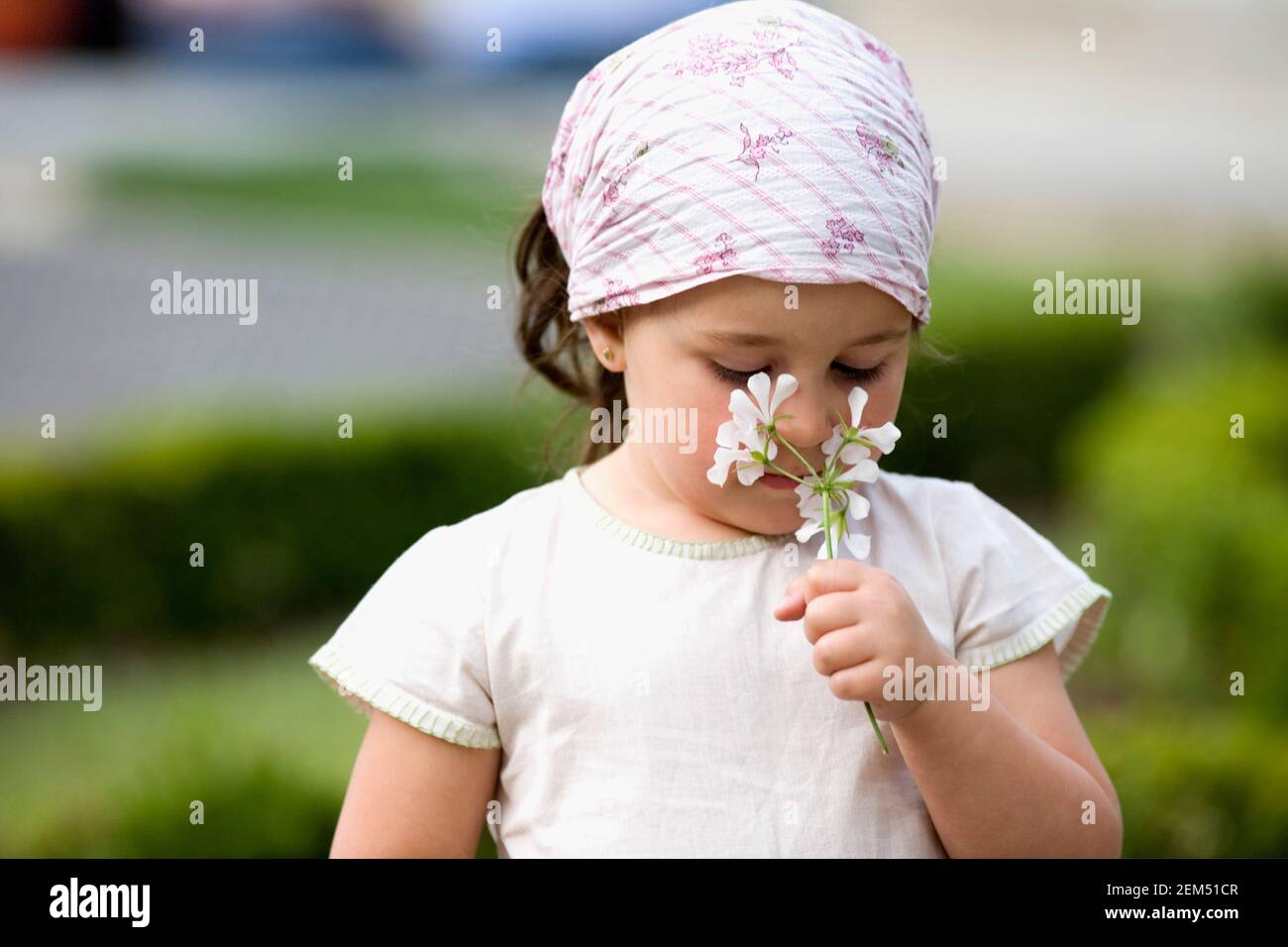 Girl smelling flowers hi-res stock photography and images - Alamy