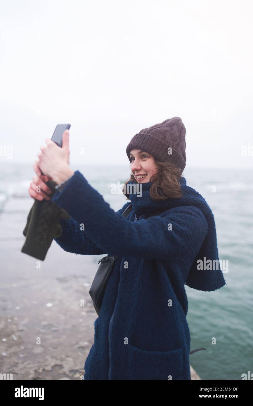 Young woman traveler using mobile phone on beach Stock Photo - Alamy