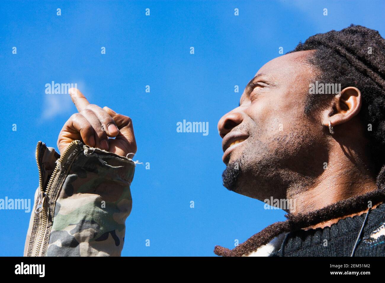 Low angle view of a young man pointing upwards Stock Photo - Alamy
