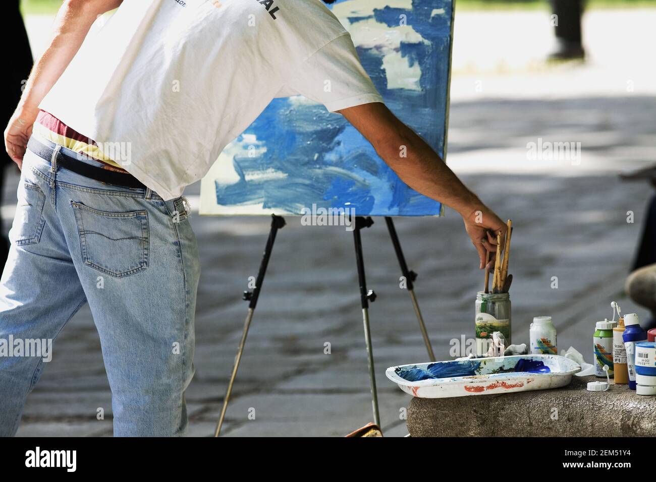 Rear view of a man painting outdoors Stock Photo - Alamy