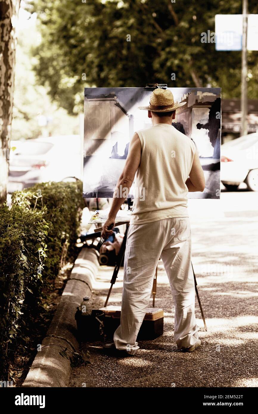 Rear view of a man painting hi-res stock photography and images - Alamy