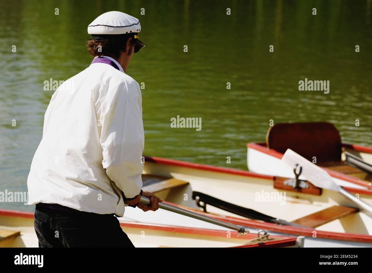 Rear view of a man standing with boats, Paris, France Stock Photo - Alamy