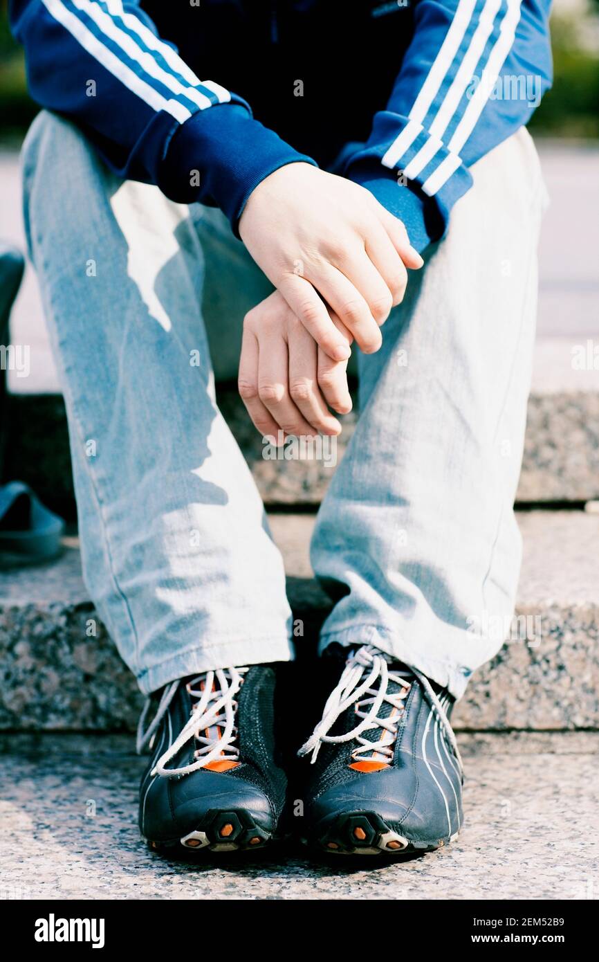 Low section view of a man sitting on steps Stock Photo - Alamy