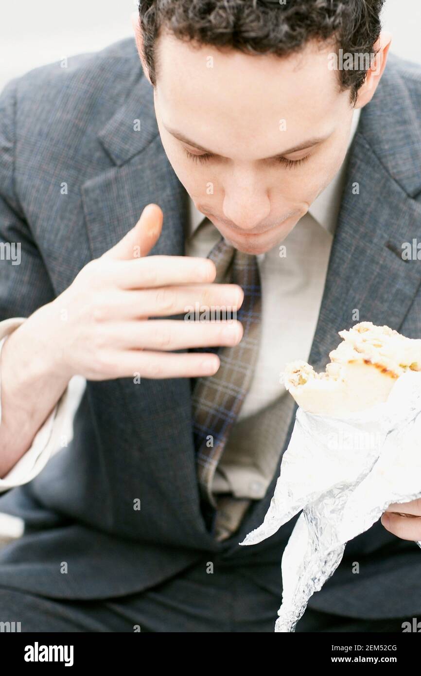 High angle view of a young man eating a sandwich Stock Photo - Alamy
