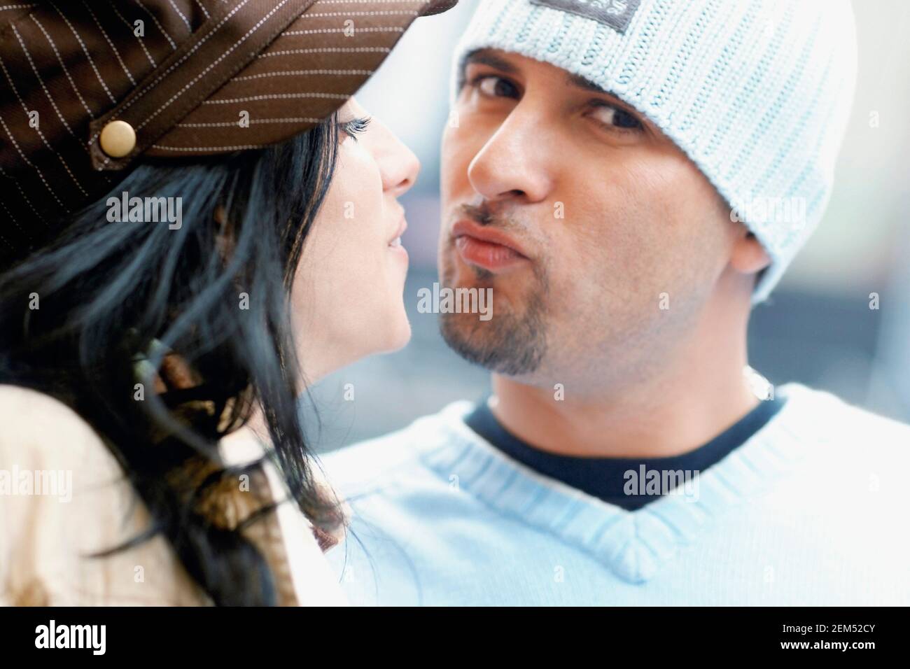 Portrait of a mid adult man kissing a mid adult woman Stock Photo - Alamy