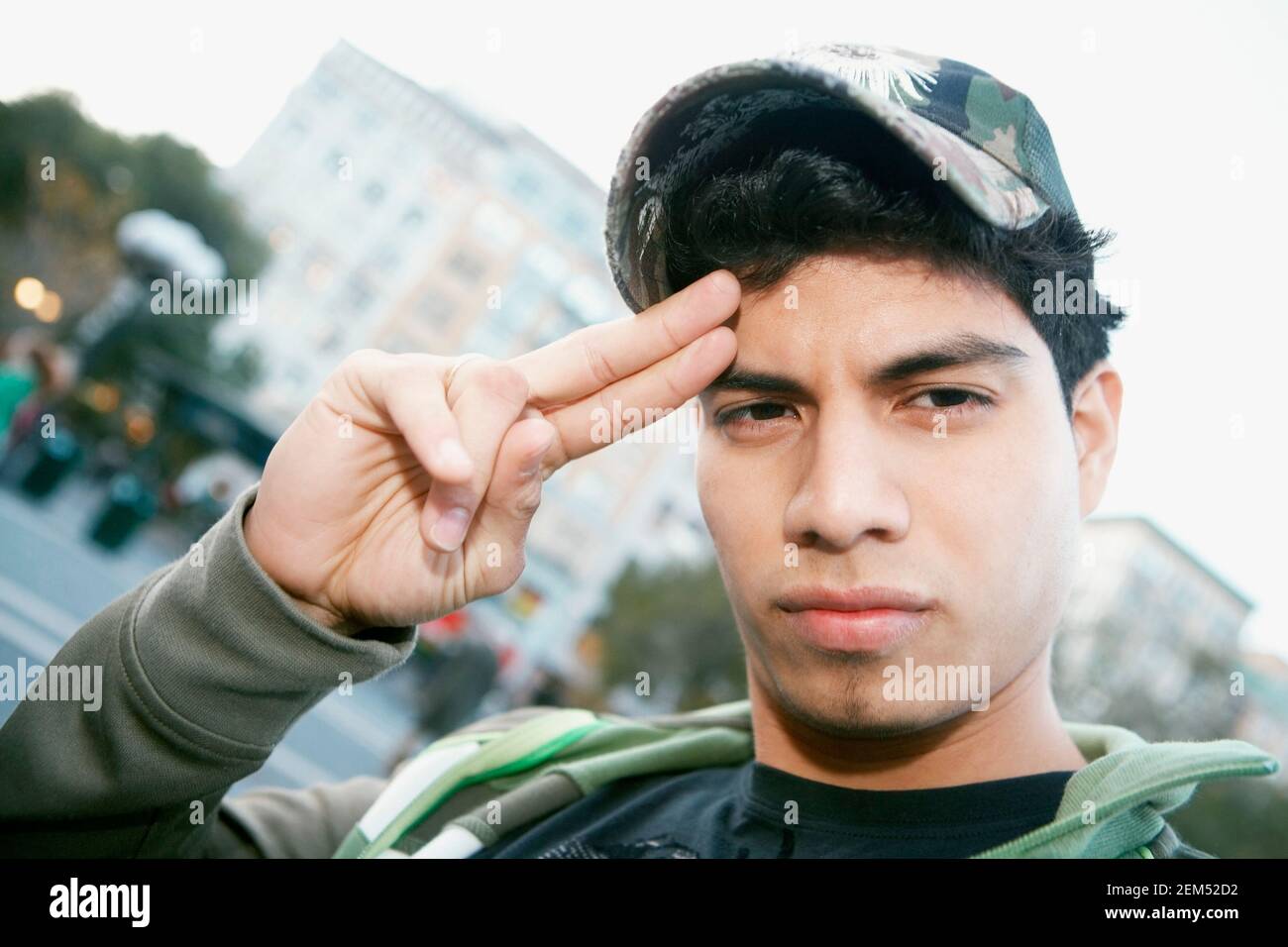 Portrait of a young man with his fingers on his forehead Stock Photo ...