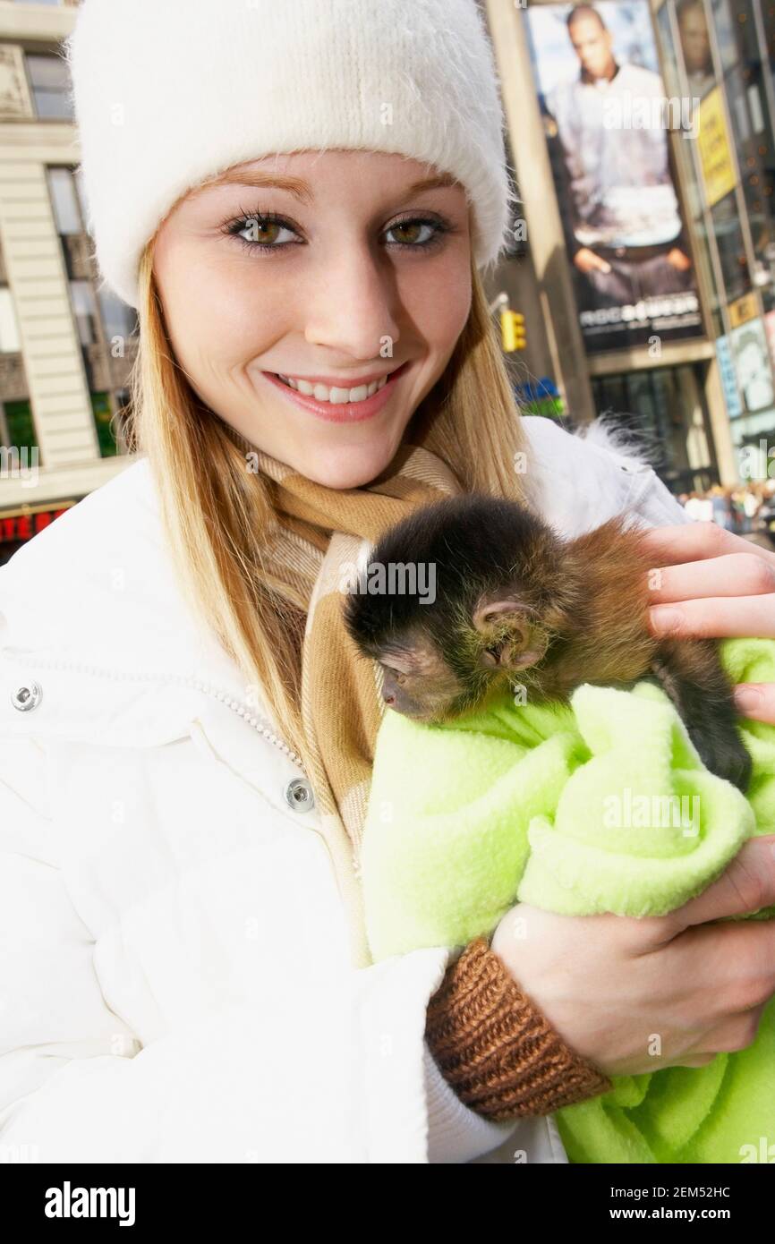 Portrait of a young woman hugging a baby monkey Stock Photo - Alamy