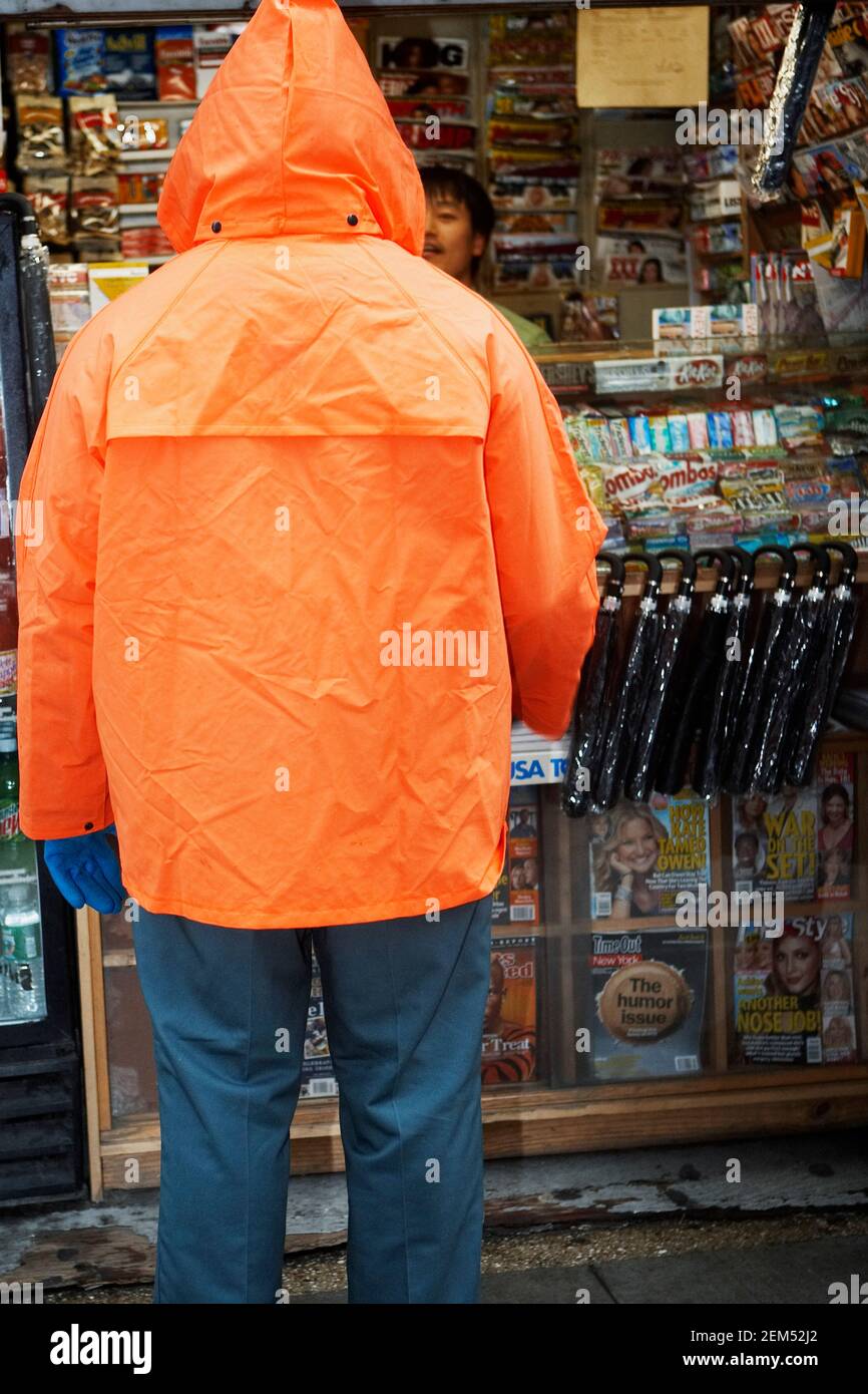 Rare view of a man standing in front of a store Stock Photo - Alamy