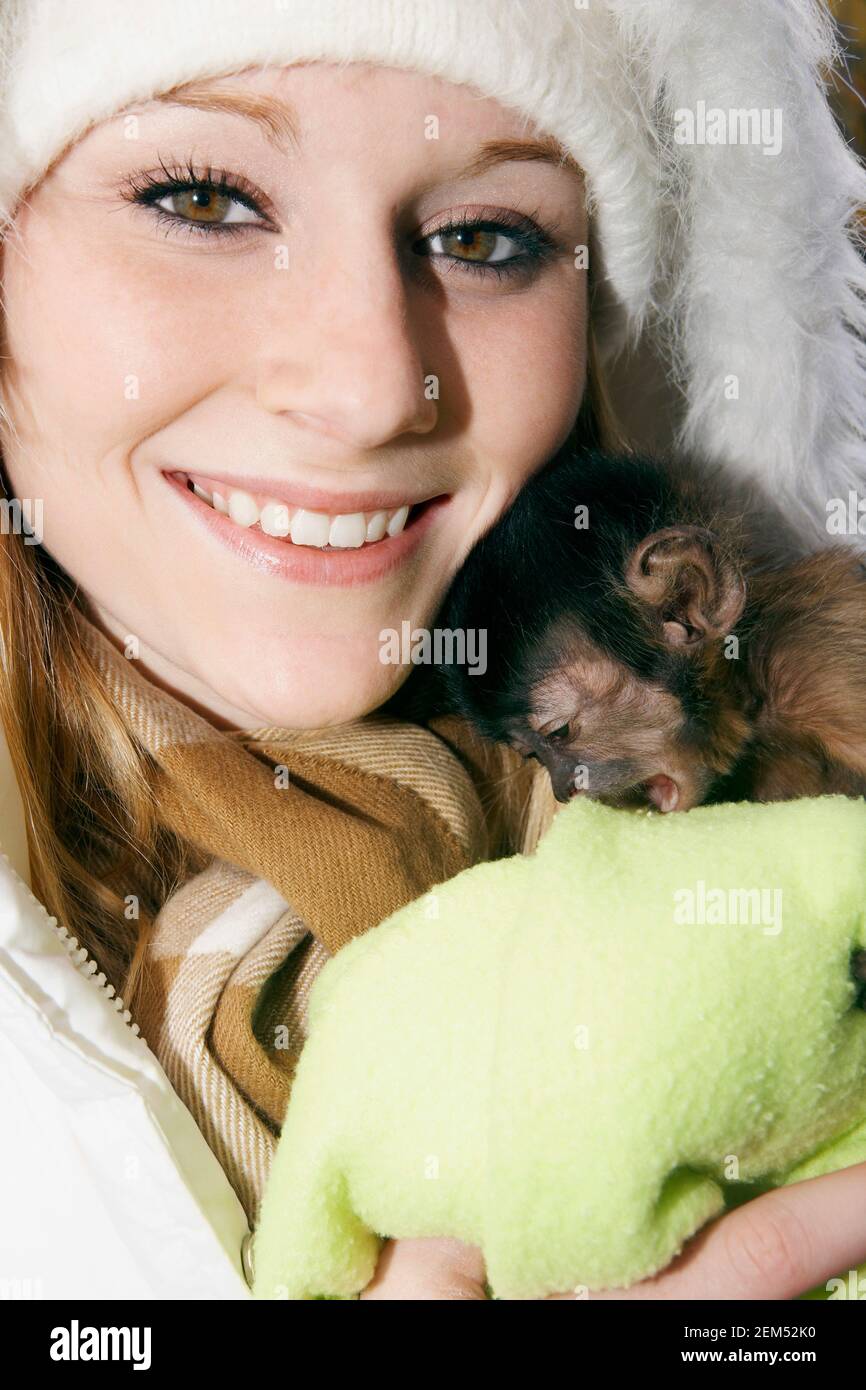 Portrait of a young woman hugging a baby monkey Stock Photo - Alamy