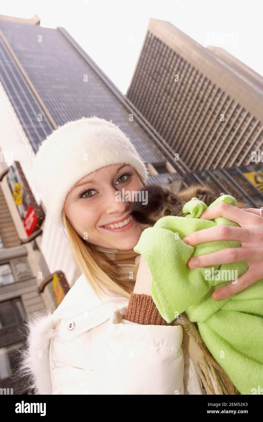 Portrait of a young woman hugging a baby monkey Stock Photo - Alamy