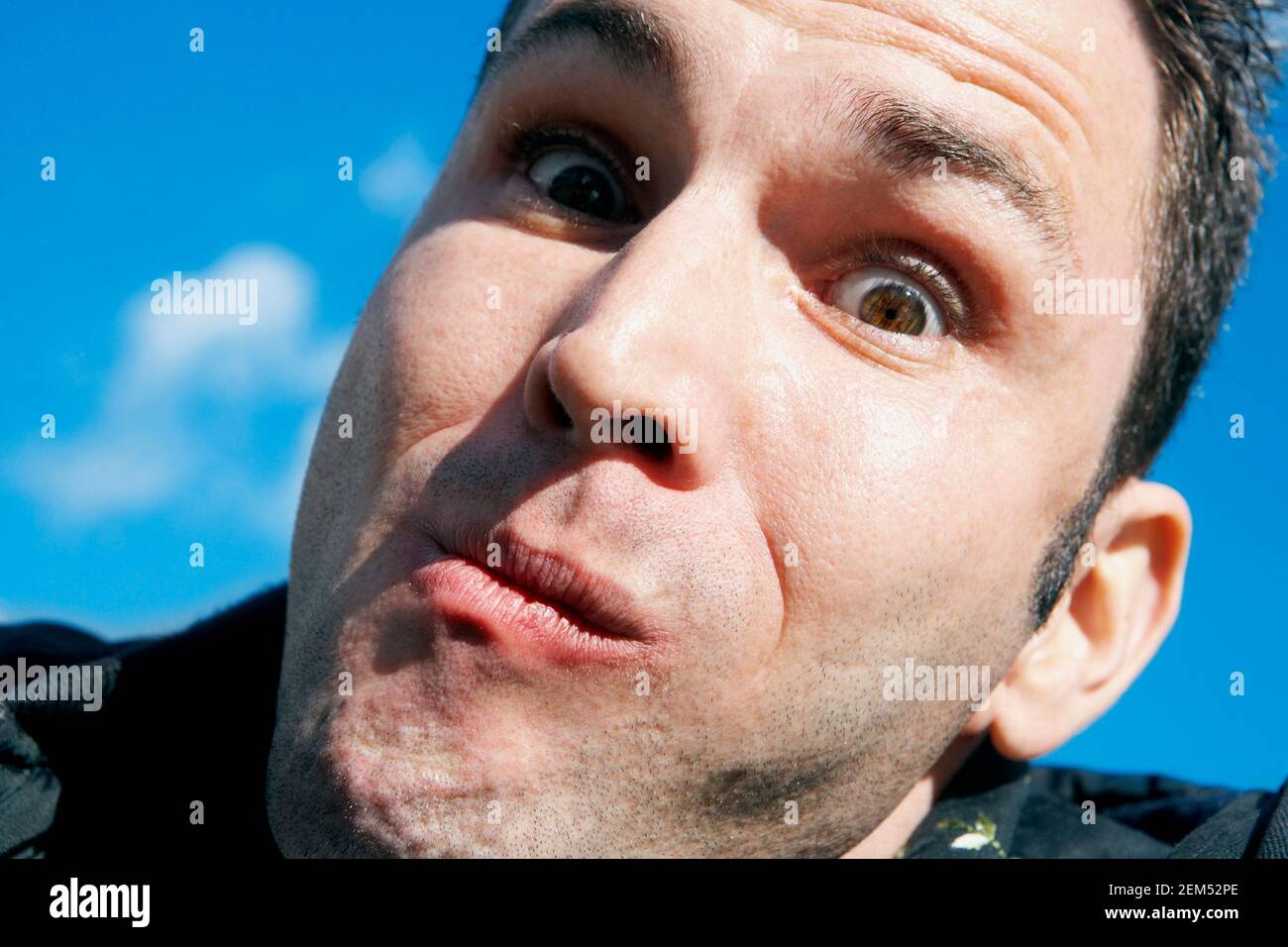 Portrait of a mid adult man making a face Stock Photo - Alamy