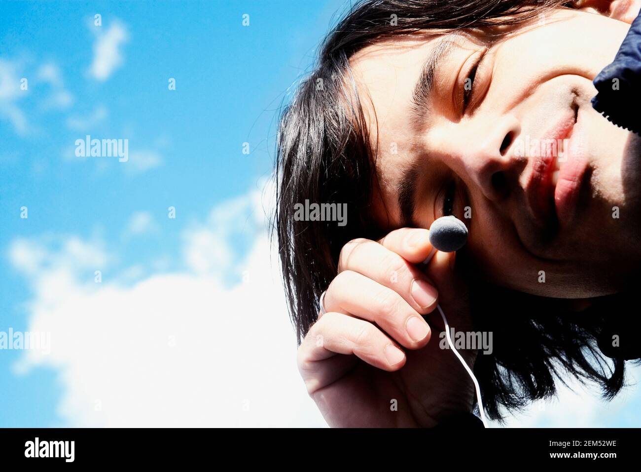 Holding to ear hi-res stock photography and images - Alamy