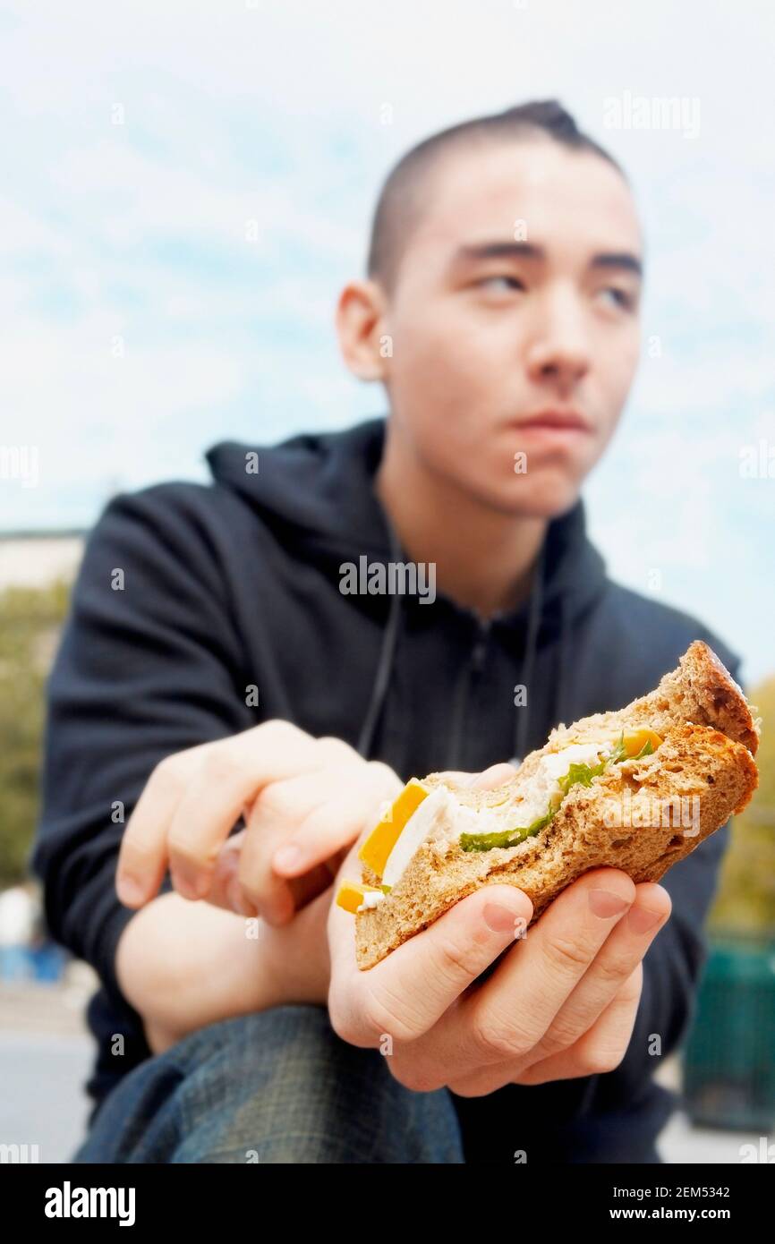 Man holding a sandwich hi-res stock photography and images - Alamy