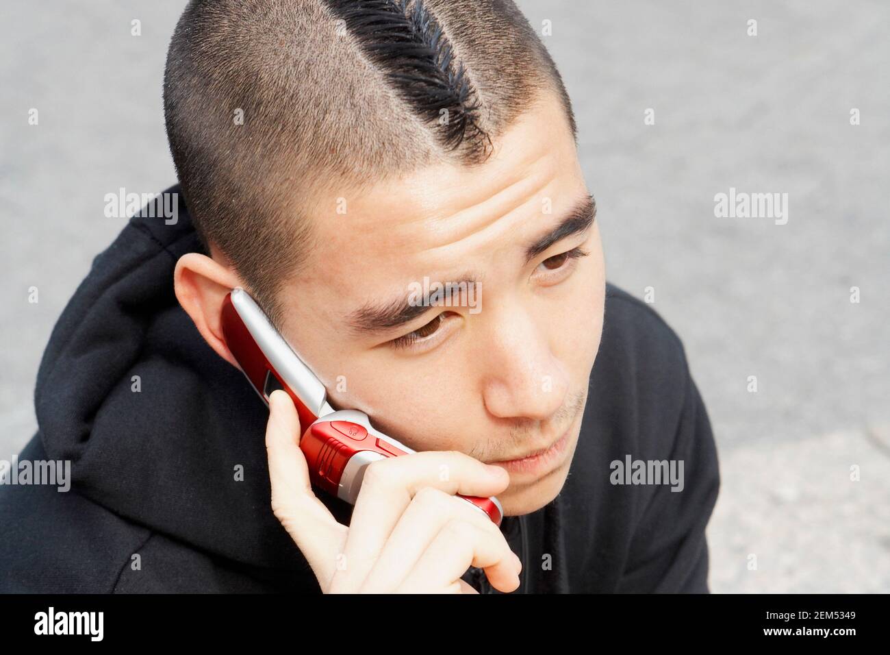 Close-up of a young man using a mobile phone Stock Photo - Alamy