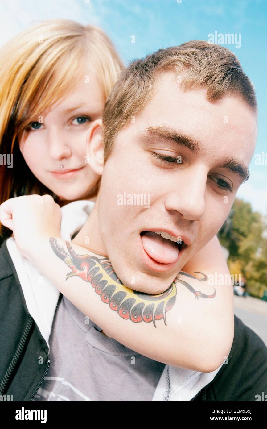 Portrait of a young woman strangling a young man Stock Photo - Alamy