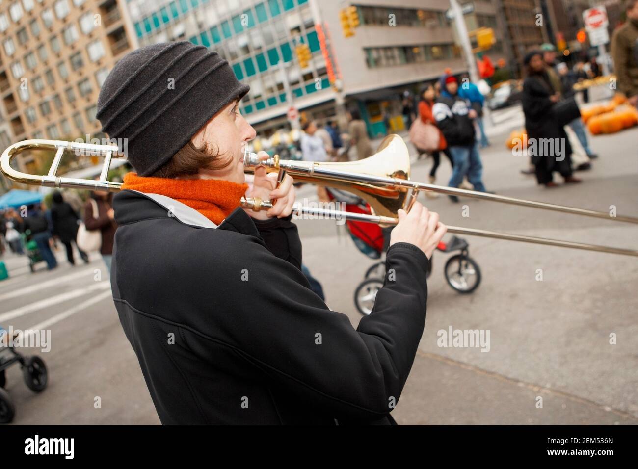Side profile of a street musician playing a trumpet Stock Photo - Alamy