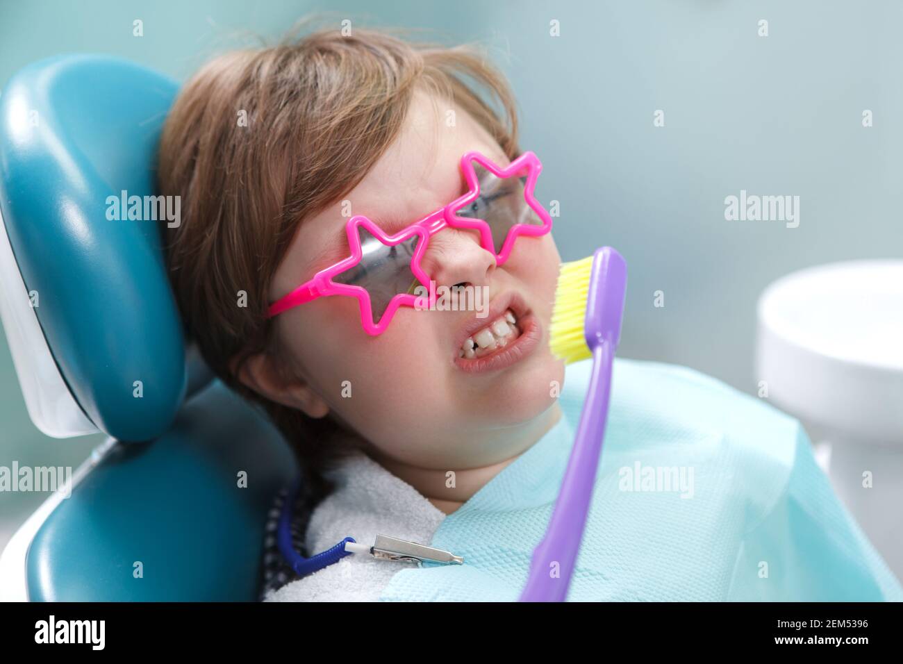 Close up of a funny young boy brushing teeth with big toothbrush Stock ...