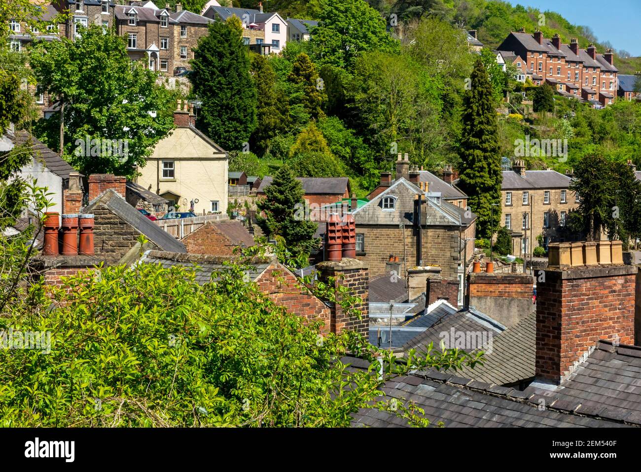 Early summer view of rooftops and chimneys in Matlock Bath a village in ...