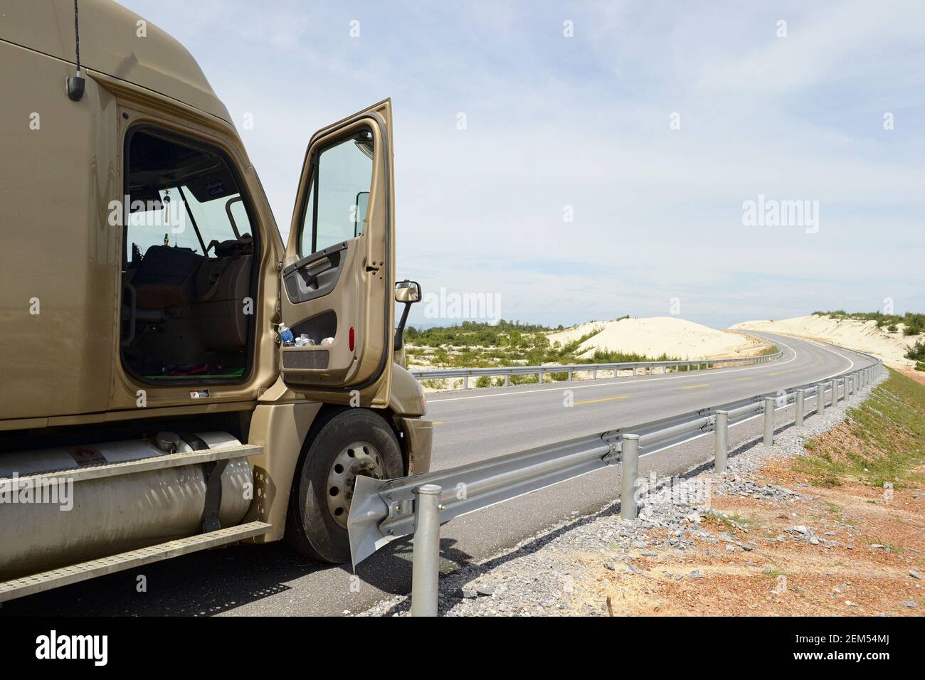 Freight truck (Freightliner) with heavy carriage on the highway through ...