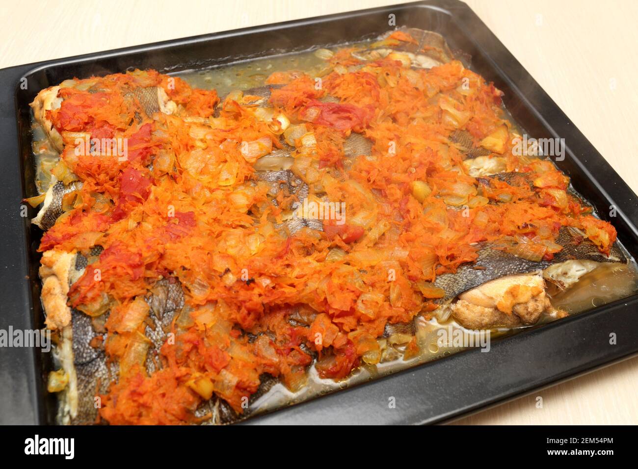 Baked fish with vegetables on a tray Stock Photo - Alamy